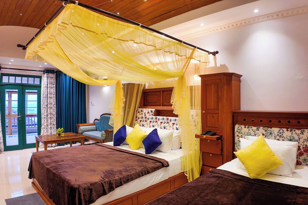 Quarto com cama grande, mesa de cabeceira, cadeira e guarda-roupa de madeira.