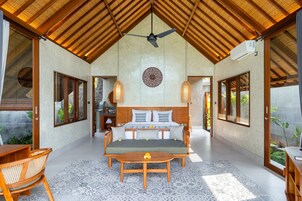 Quarto espaçoso com cama grande, teto de madeira e ventilador de teto.