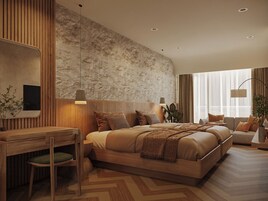 Quarto moderno com uma cama grande, uma escrivaninha e uma cadeira.