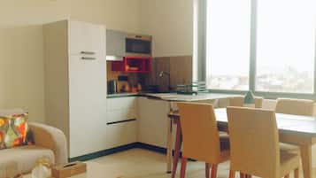 Apartamento Premier | Cozinha privada | Um micro-ondas, uma placa de cozinha, uma cadeira de bebé