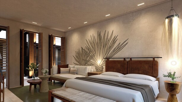 Quarto moderno com cama grande, um banco, um sofá e uma obra de arte na parede.