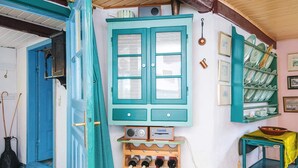 Um quarto com um armário verde-água, um suporte para vinhos e um escorredor de louça.