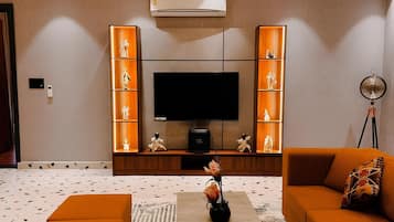 Quarto luxo, vista para o jardim | Área de estar