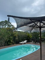 Piscina externa, guarda-sóis, espreguiçadeiras