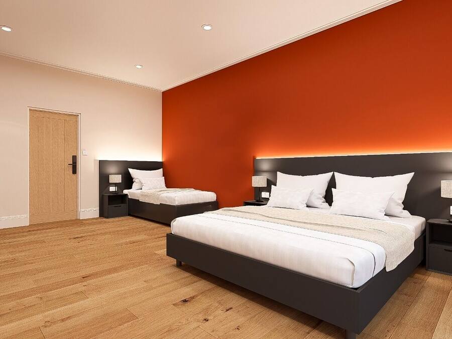 Quarto moderno com uma cama grande, duas mesas de cabeceira e um guarda-roupa.