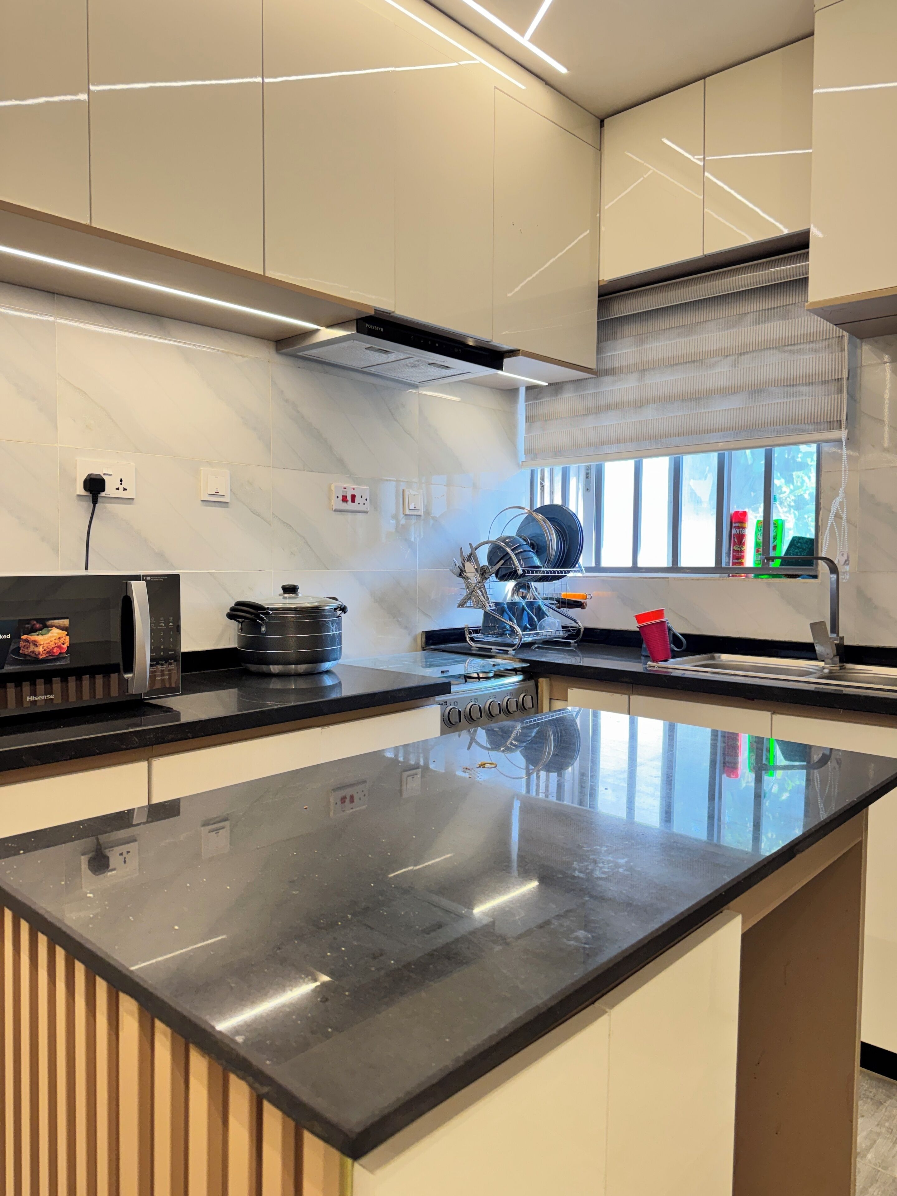 Um frigorífico, um micro-ondas, um forno, utensílios de cozinha 