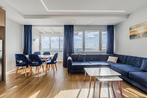 Apartamento Deluxe, vista para o mar | Sala de estar | TV de ecrã plano