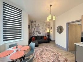 Apartamento conforto, 1 quarto | Área de estar