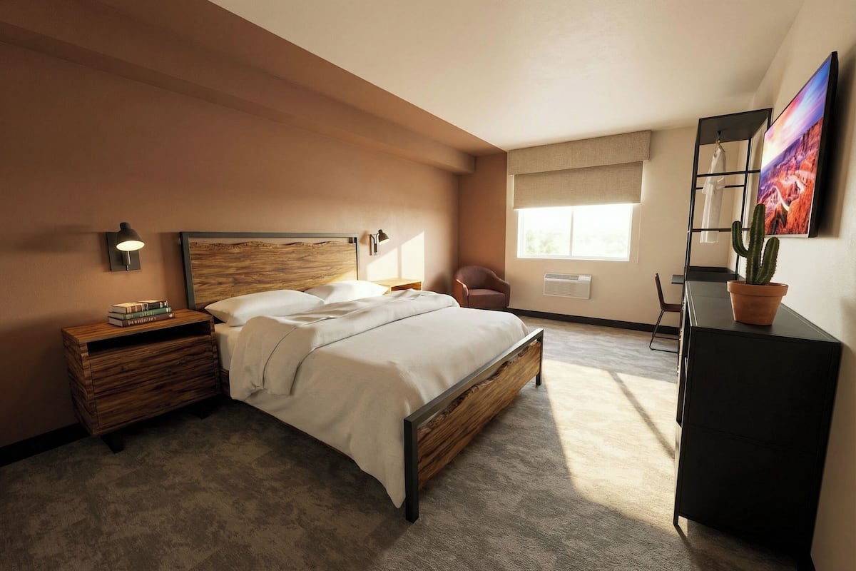 Quarto com cama de madeira, mesa de cabeceira com livros, escrivaninha com um cacto e uma janela ampla com vista.