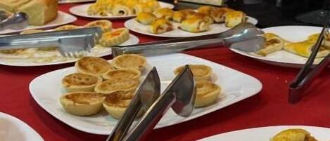 Uma mesa de buffet com diversos doces e um certificado emoldurado.