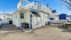 Uma casa de dois andares com varanda, alpendre e garagem.