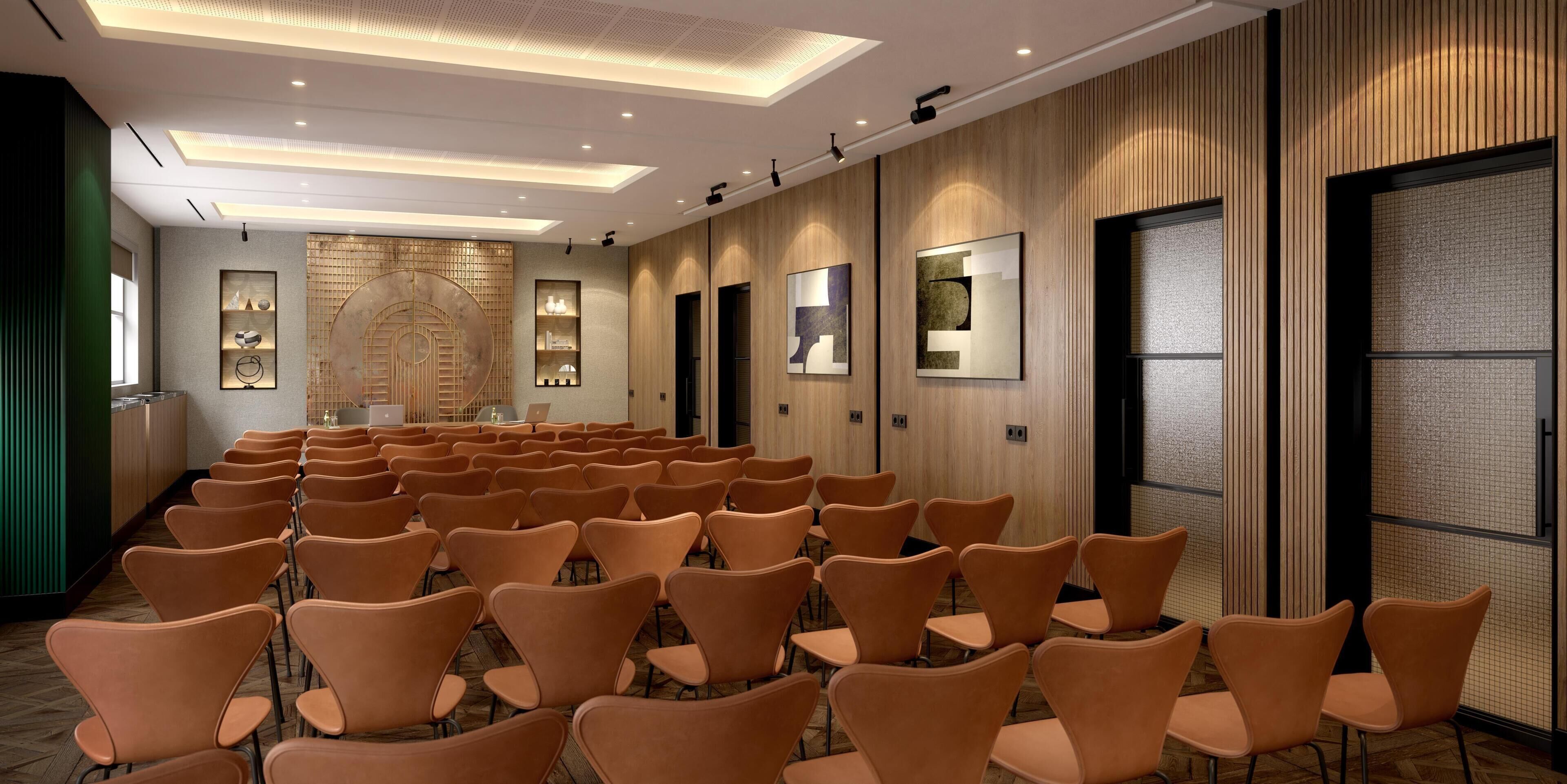 Uma sala de conferências com fileiras de cadeiras, uma parede de madeira com obras de arte emolduradas e um design moderno no teto.