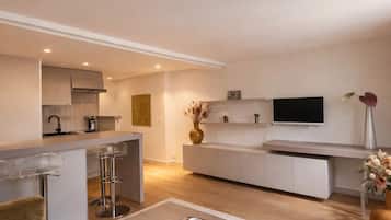 Apartamento Deluxe, Vista para a cidade | Sala de estar | Smart TV de 80 cm com canais digitais