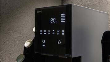 A black electronic device with a digital display reading "120 ml" and several control buttons.