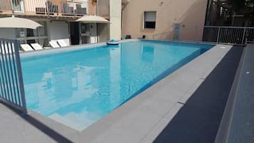 Piscina externa sazonal, funciona das 9h às 21h, guarda-sóis
