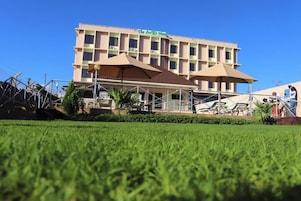 Hotel com telhado plano, várias varandas e áreas de estar ao ar livre.