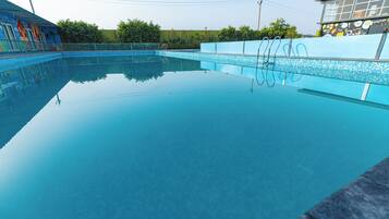 Piscina límpida com borda azulejada e escada.