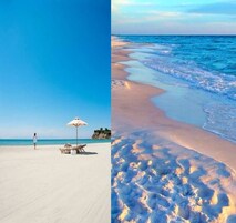 Uma praia com céu claro, uma pessoa caminhando e um guarda-sol.