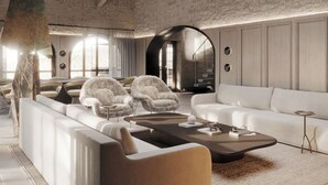 Uma sala de estar moderna com um sofá branco, poltronas e uma mesa de centro.