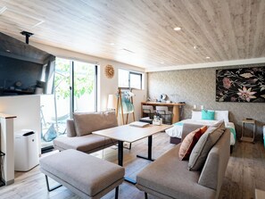 Uma sala de estar moderna com um sofá, mesa de centro e um quadro na parede.