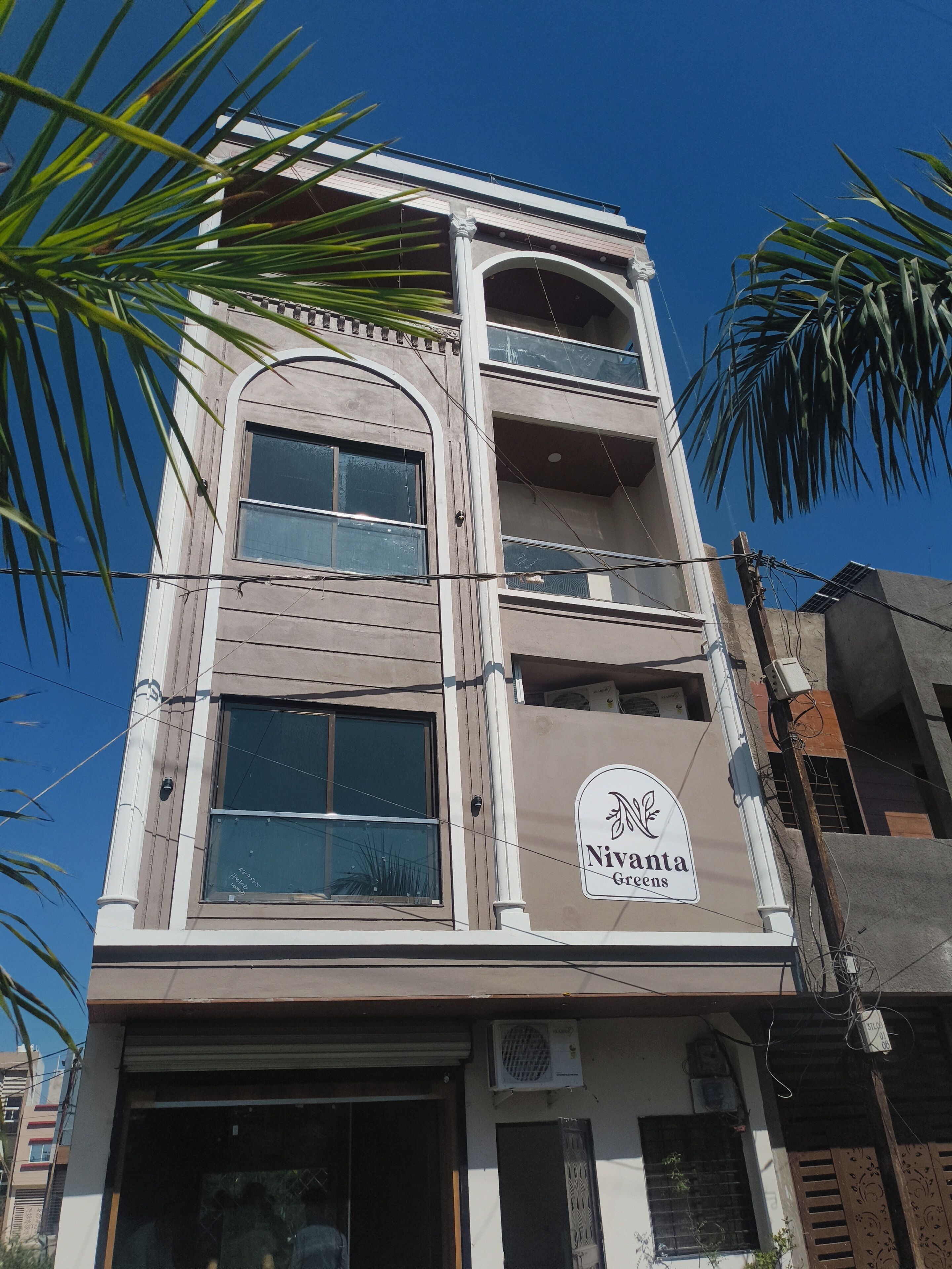 Um edifício de vários andares com uma placa que diz 'Nivanta Green'.