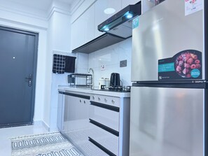 Apartamento, sacada, vista para a cidade | Cozinha privada