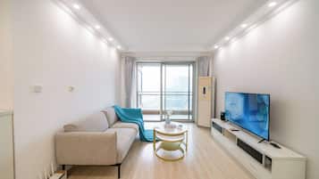 Suíte superior, várias camas, para não fumantes, vista para a cidade | Sala de estar