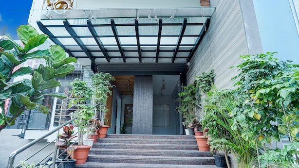 Uma escadaria leva à entrada de um edifício, com uma cobertura sobre ela.