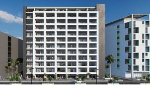 Um edifício de vários andares com uma fachada de janelas em grade, telhado plano e estilo arquitetônico moderno.