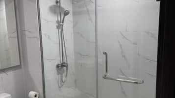 Um secador de cabelo, toalhas fornecidas, sabão, champô