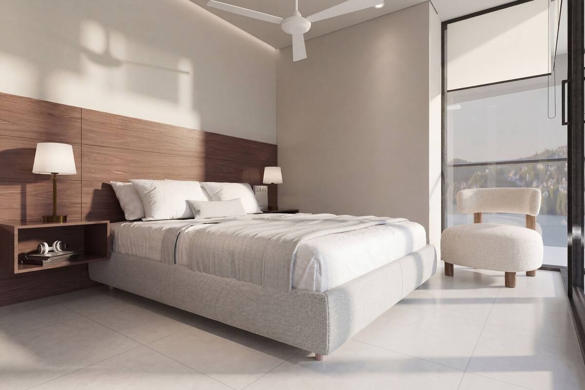 Quarto moderno com uma cama grande, mesas de cabeceira, luminária de pé, uma cadeira e vista para o exterior.