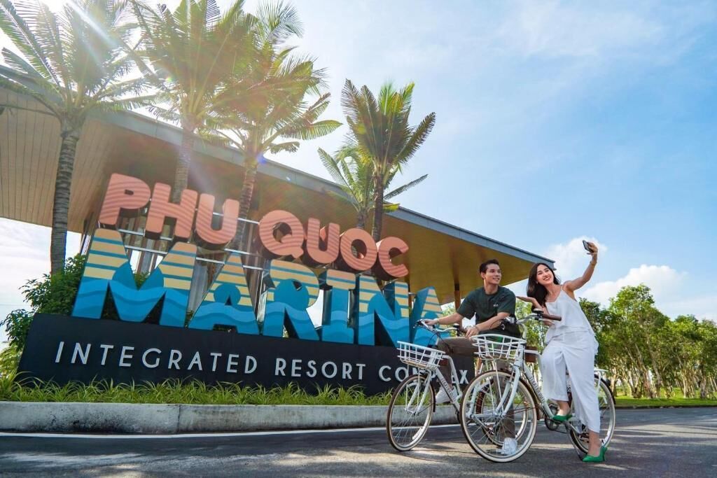 Placa de PHU QUOC MARINA com uma bicicleta e duas pessoas.
