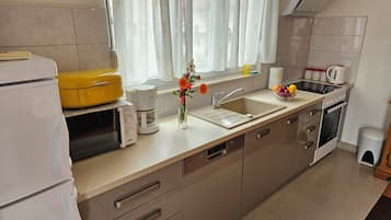 Apartamento, varanda | Cozinha privada