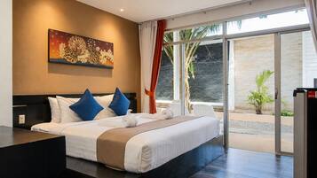 Quarto de hotel com uma cama grande, um quadro na parede e vista para o exterior.