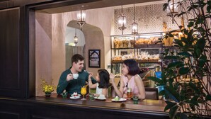 Restaurante com área de bar, onde pessoas estão jantando.