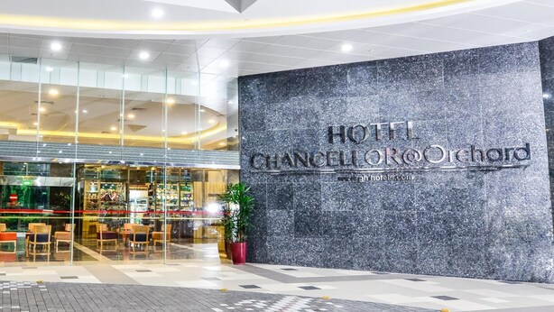 Uma entrada de hotel moderna com uma placa de destaque que diz "HOTEL CHANCELLOR GROORCHORD".