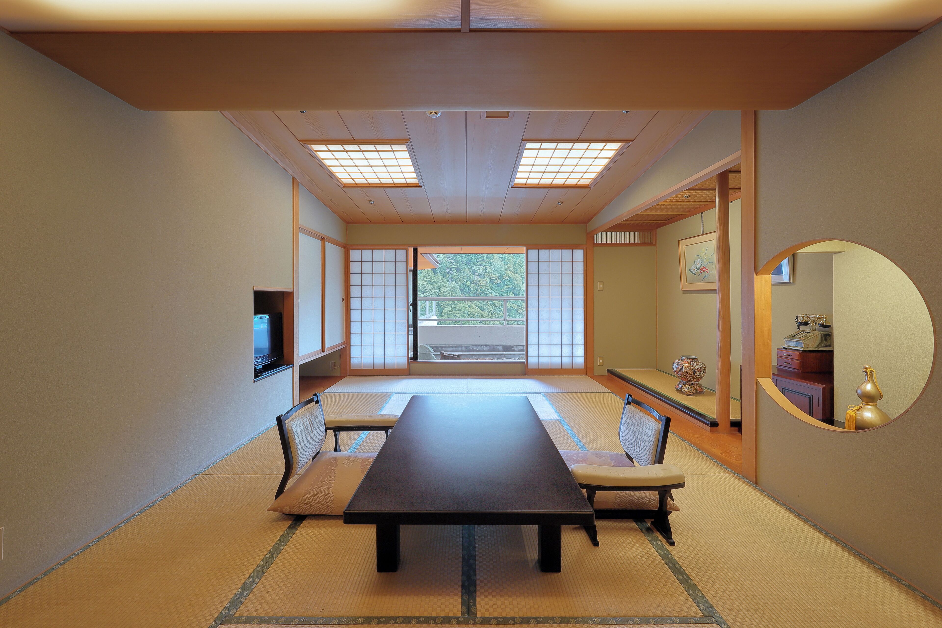 Um quarto japonês tradicional com piso de tatame, uma mesa baixa e painéis shoji.