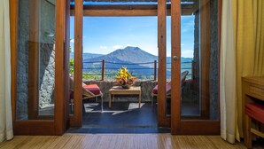 Quarto com vista para uma montanha e uma mesa com uma planta.