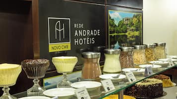 Exposição de sobremesas nos Hotéis Rede Andrade, com diversos doces e uma placa indicando 'Margarita Margarita'.