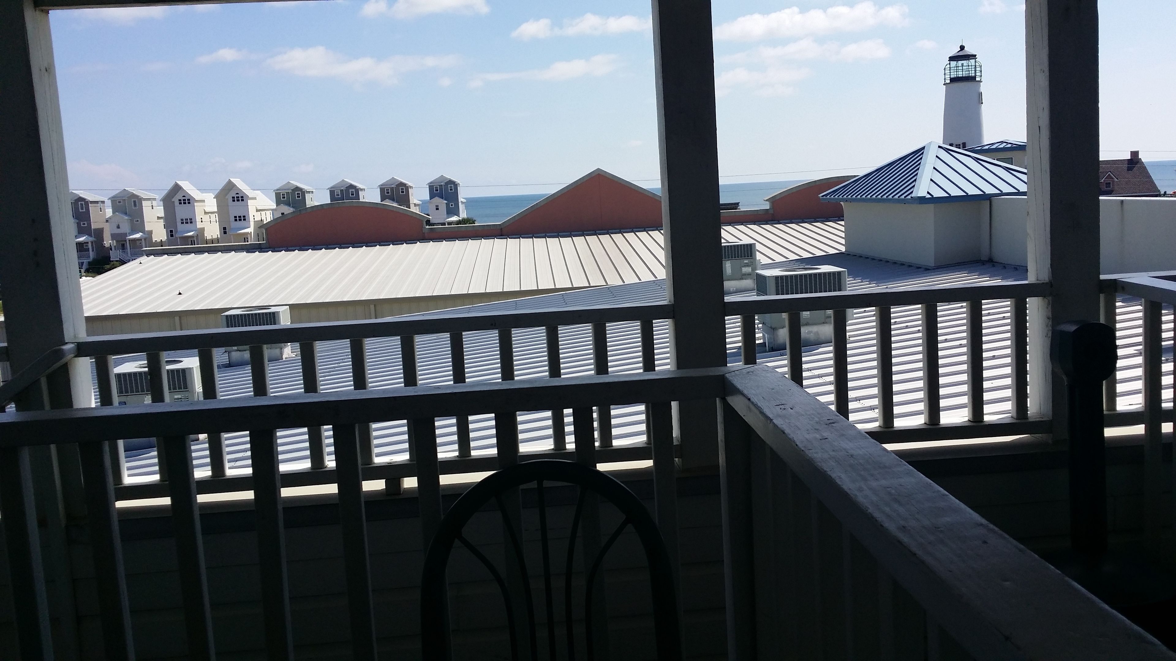 Varanda com vista para edifícios e um farol.