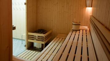 Uma sala de sauna com bancos de madeira e um banco com assento aquecido.