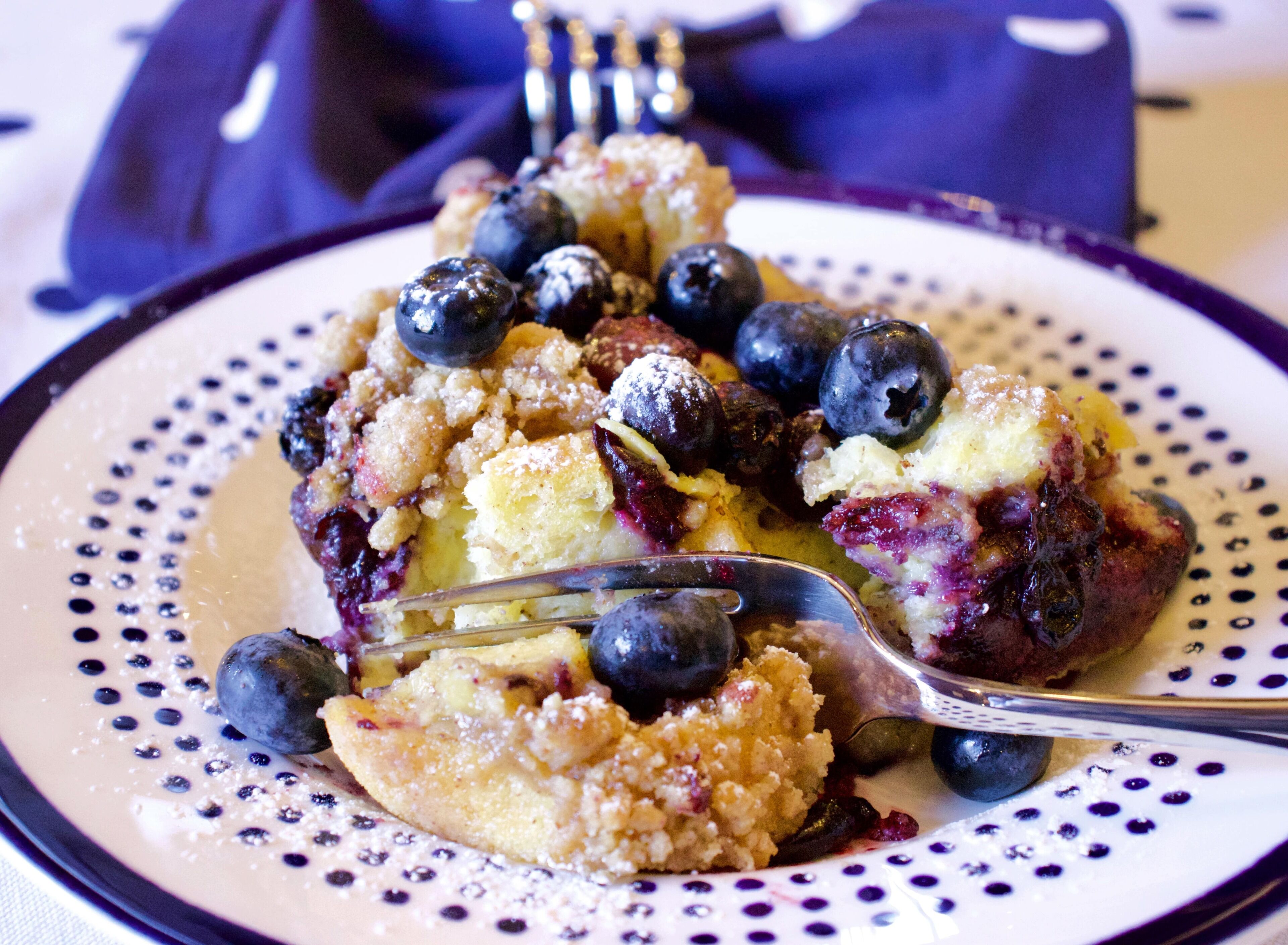 Sobremesa com blueberries e cobertura esfarelada num prato.