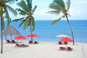 Praia particular, espreguiçadeiras, guarda-sóis, toalhas de praia 