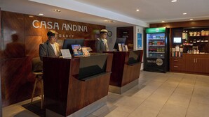 Uma receção com uma placa a indicar 'CASA ANDINA ELECT' e um frigorífico 'sama 2Go!'.