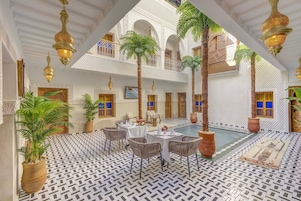 Amplo espaço interno com piscina, vários assentos e iluminação decorativa.