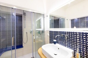 Apartamento Deluxe, vista para o mar | Casa de banho | Um polibã, artigos de higiene pessoal grátis, um secador de cabelo 