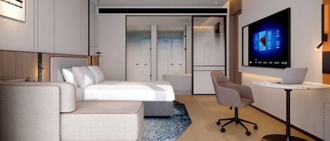 Quarto de hotel moderno com cama, sofá, escrivaninha com laptop, televisão e guarda-roupa.