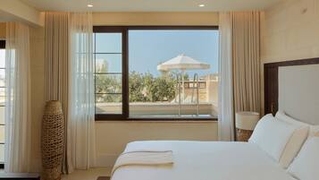 Quarto de hotel com uma cama grande, vista para a paisagem urbana e varanda com guarda-sol.