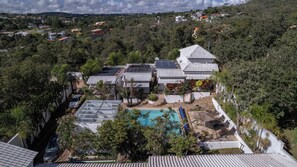 Um bairro residencial com várias casas, uma piscina e muita vegetação.