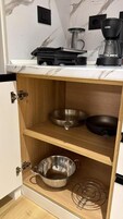 Um frigorífico, uma placa de cozinha, utensílios de cozinha